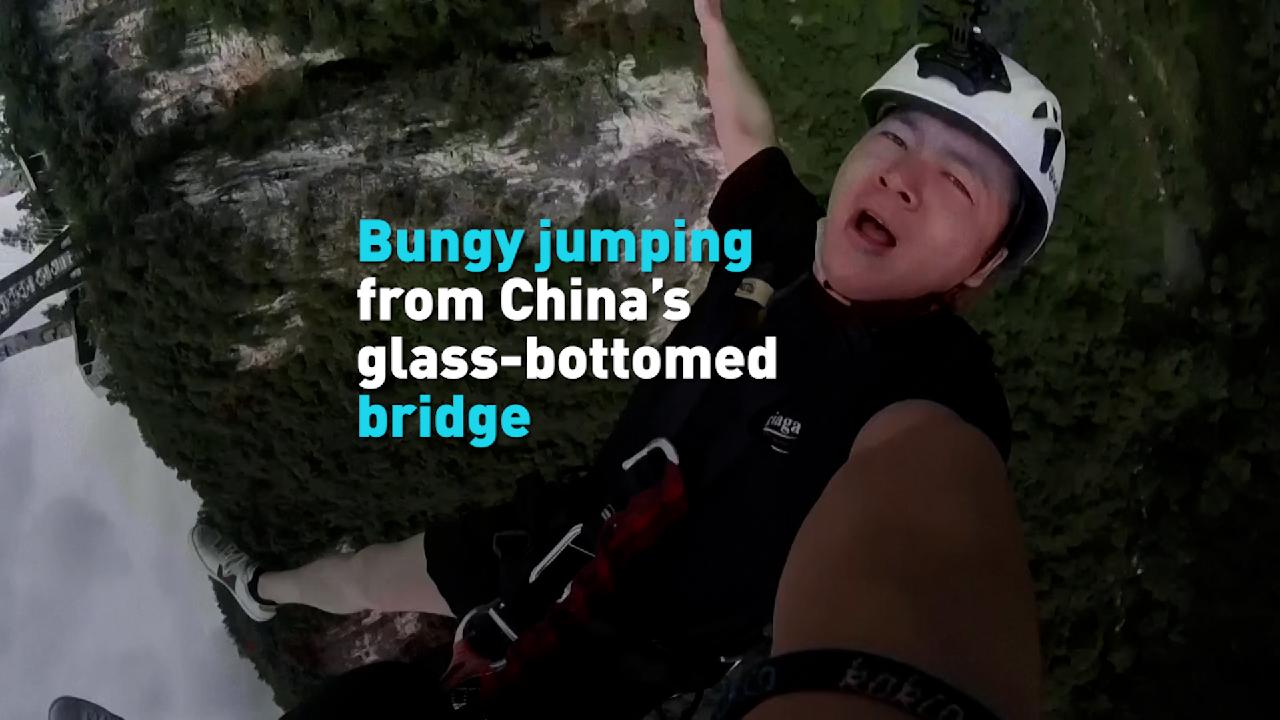 Bungy jumping from the world's highest glass-bottomed bridge in China ...