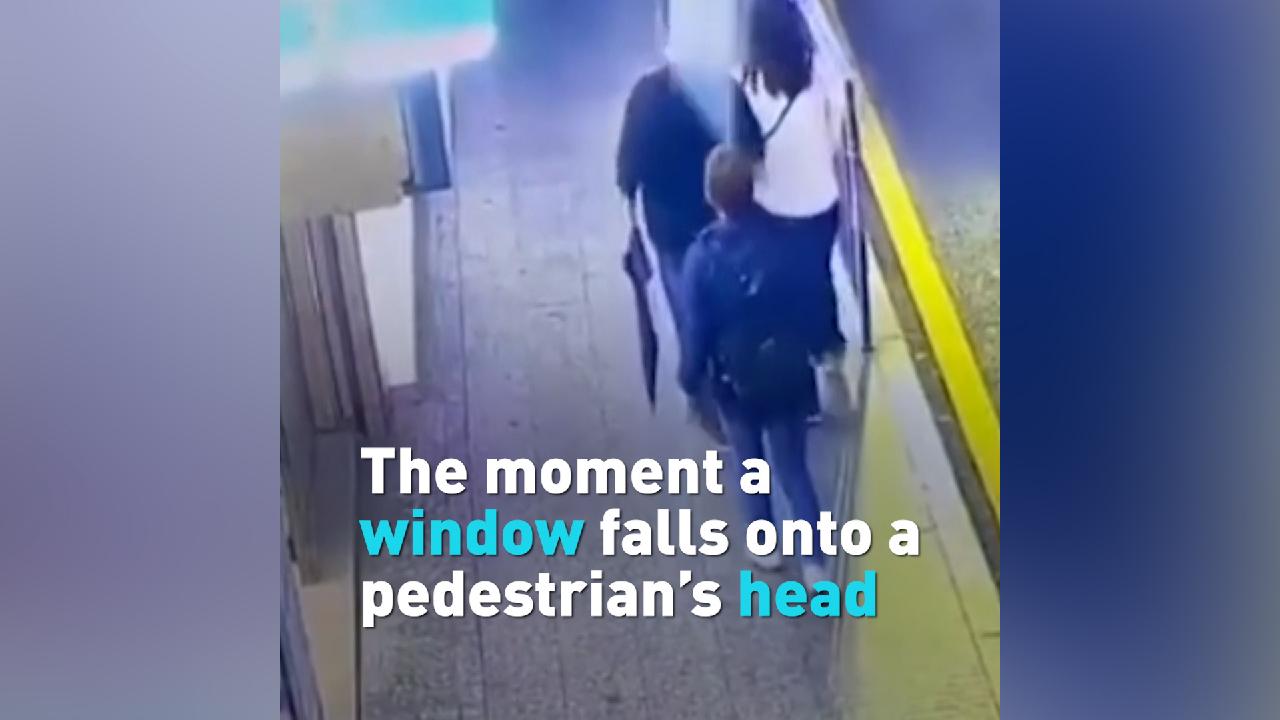 The moment a window falls onto a pedestrian's head - CGTN